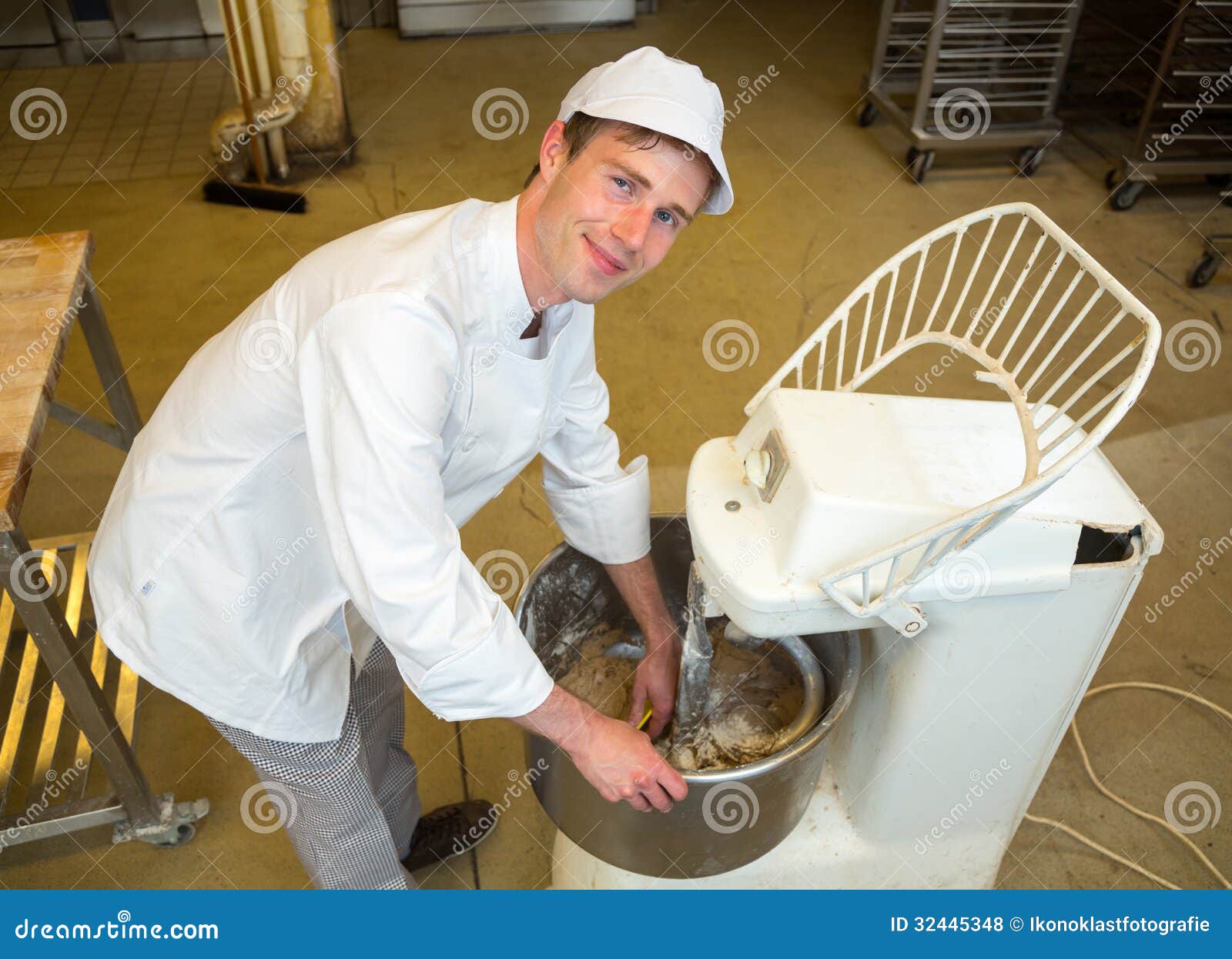Baker with Dough Kneading Machine in Bakery Stock Photo - Image of ...