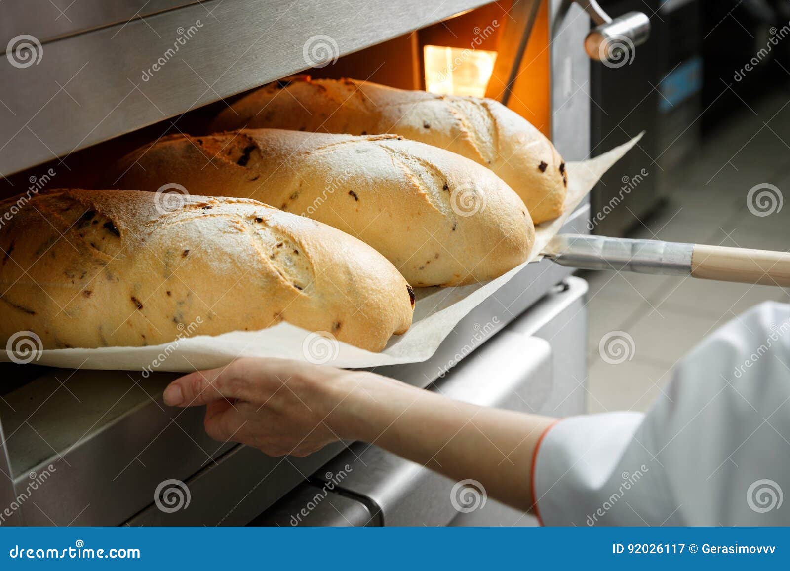 Baker Gets Hot Bread Out of the Oven Stock Image - Image of loaf ...