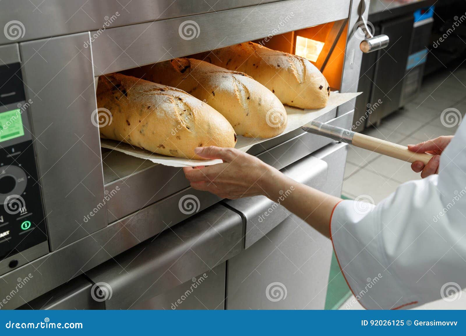 Baker Gets Hot Bread Out of the Oven Stock Image - Image of production ...