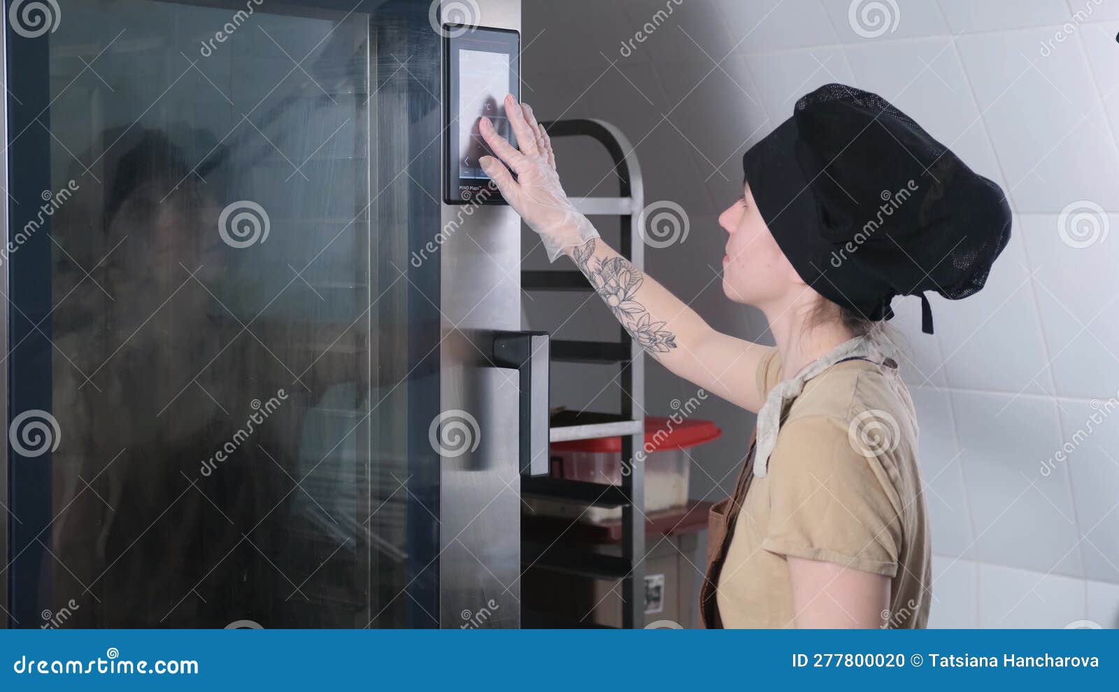 The Baker Girl Touches the Oven Control Panel with Her Finger. Stock ...
