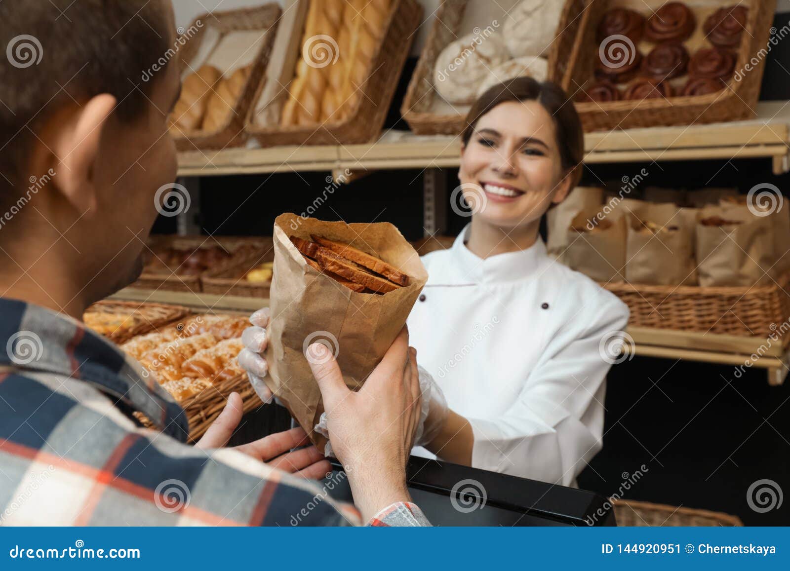 Baker Giving Customer Paper Bag with Pastry Stock Image - Image of ...