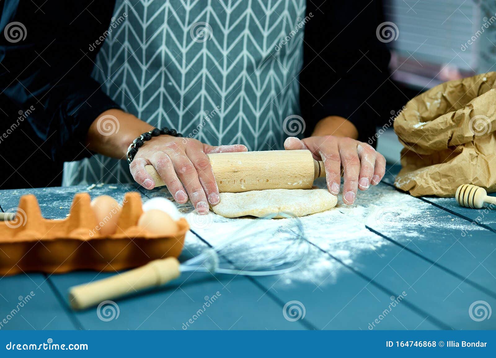Man Forming the Dough on a Floured Surface and Kneading it with His ...