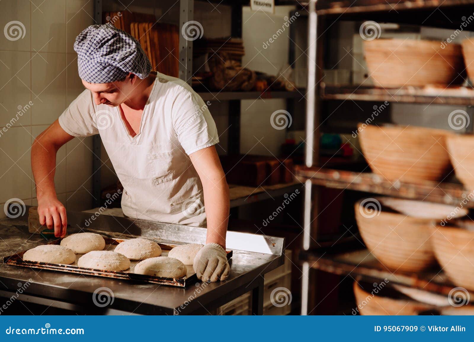 A Baker Makes Manual Incisions on the Dough for the Bread. the ...