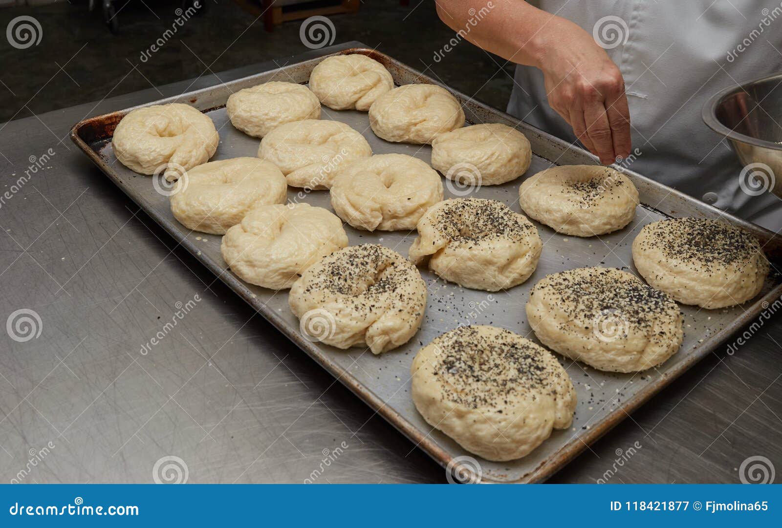 Baker Making Bagel, Adding Seeds Stock Image - Image of kitchen, bagel ...