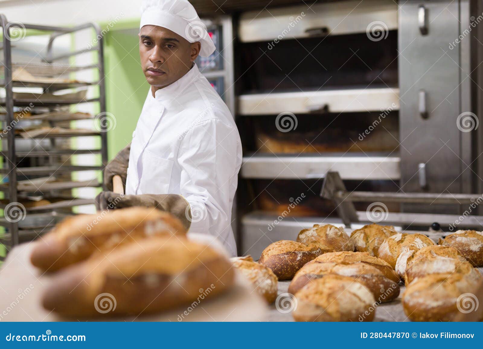 Baker Pulls Hot Bread Out of Oven Stock Photo - Image of baker, person ...