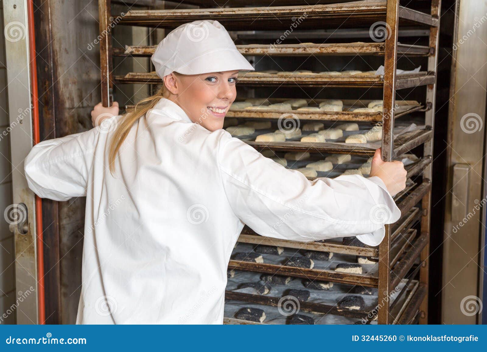 Baker Pushing Rack Full of Bread into the Oven Stock Photo - Image of ...
