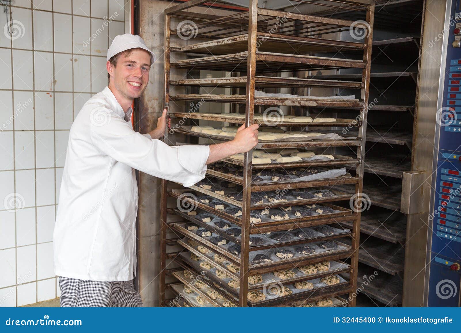 Baker Pushing Rack Full of Bread into the Oven Stock Photo - Image of ...