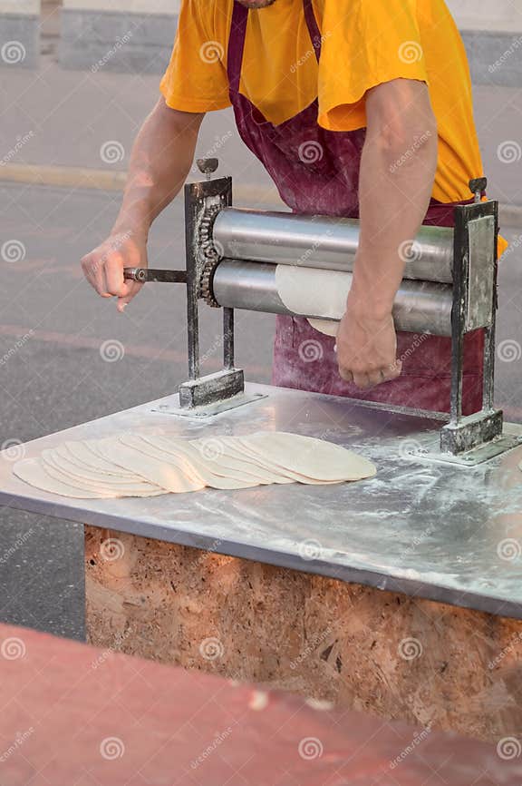 Baker is rolling a dough stock photo. Image of cooking - 65132770