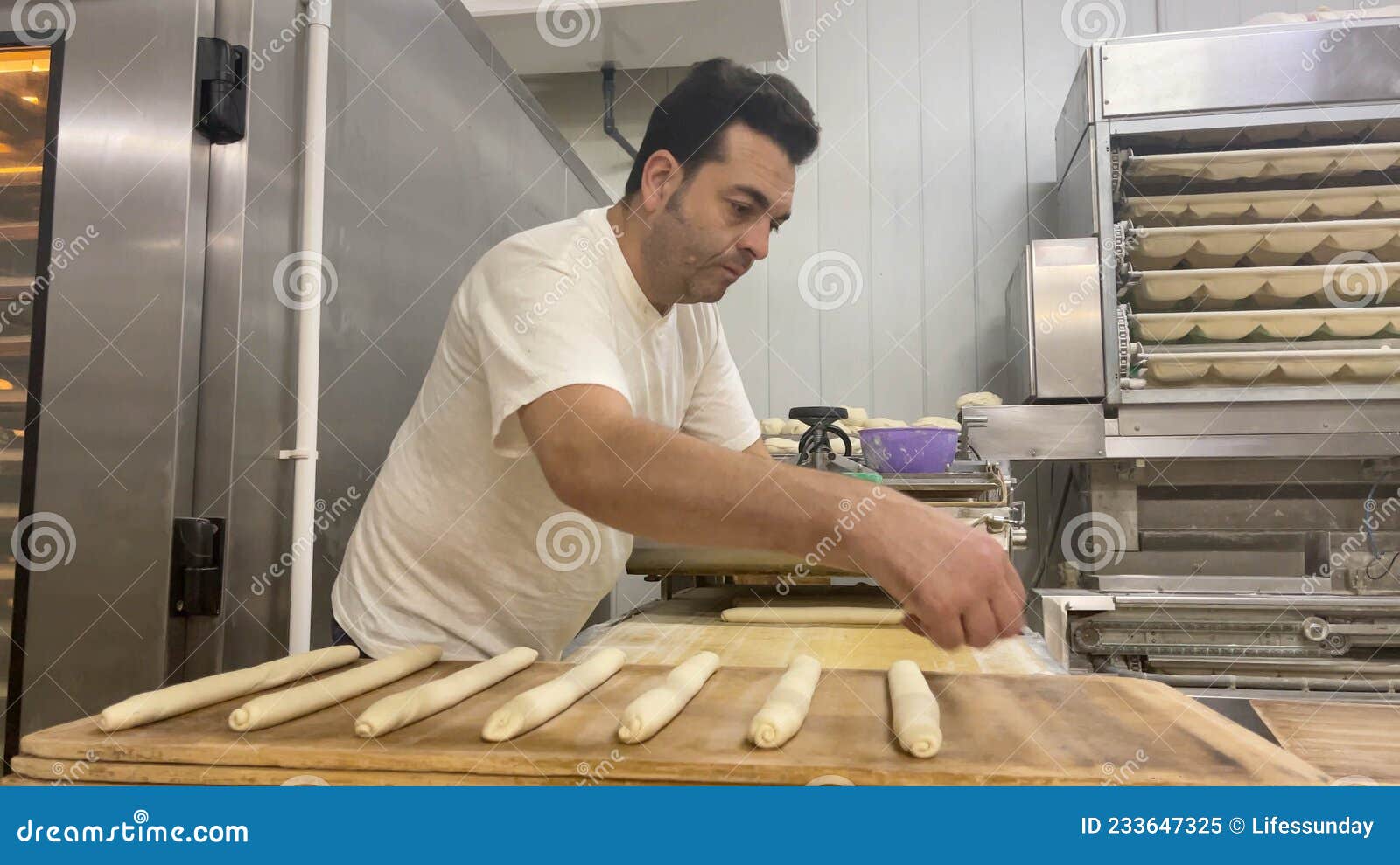 Baker Rolling Out Dough on the Table To Create Loaves of Bread in His ...