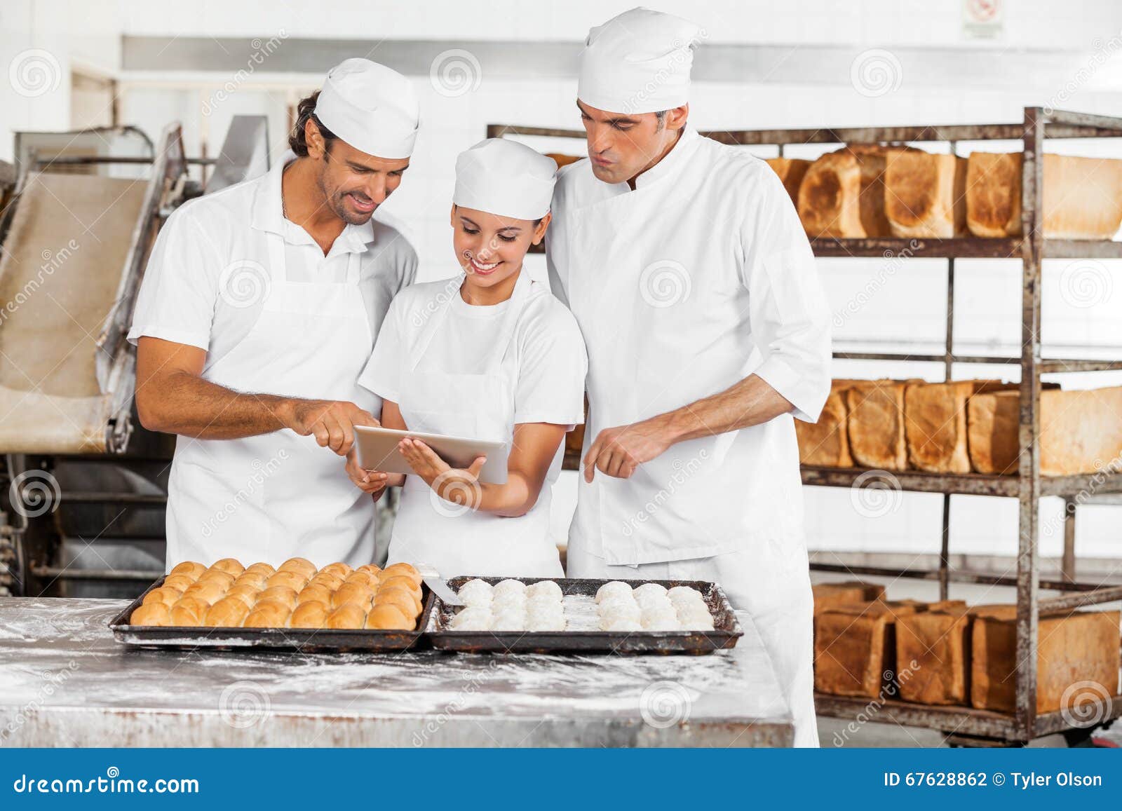 Baker S Using Tablet Computer Together in Bakery Stock Photo - Image of ...