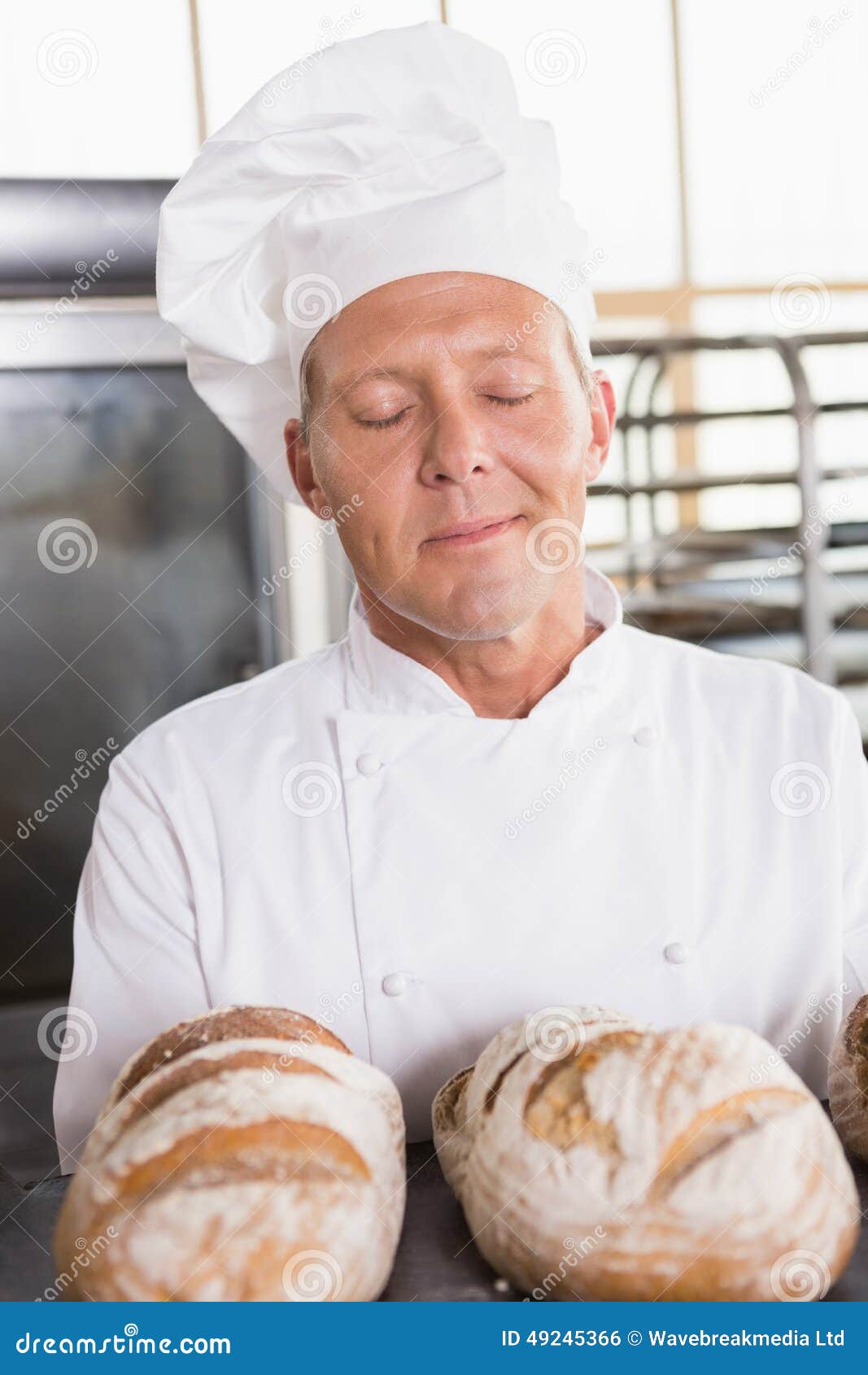 Baker Smelling Freshly Baked Breads Stock Photo - Image of business ...