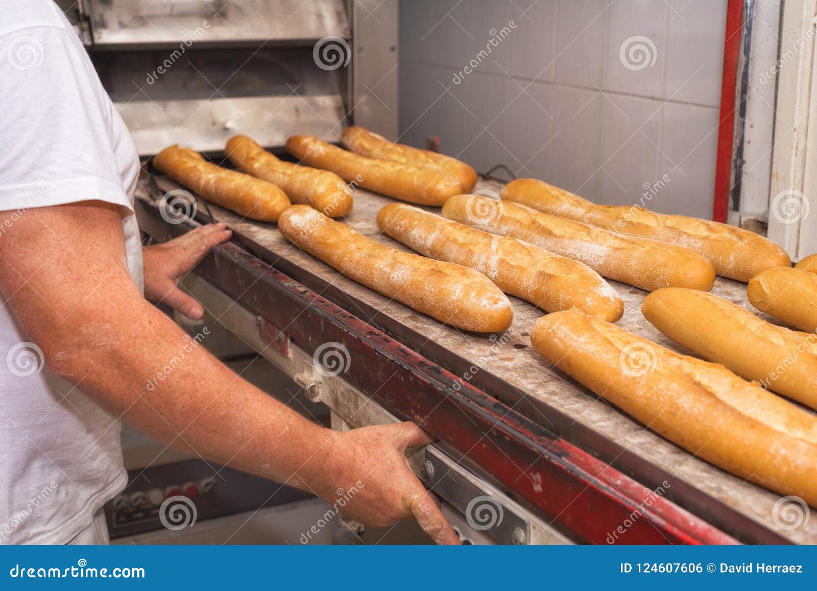 Baker Taking Out Fresh Baked Bread from the Industrial Oven Stock Photo ...