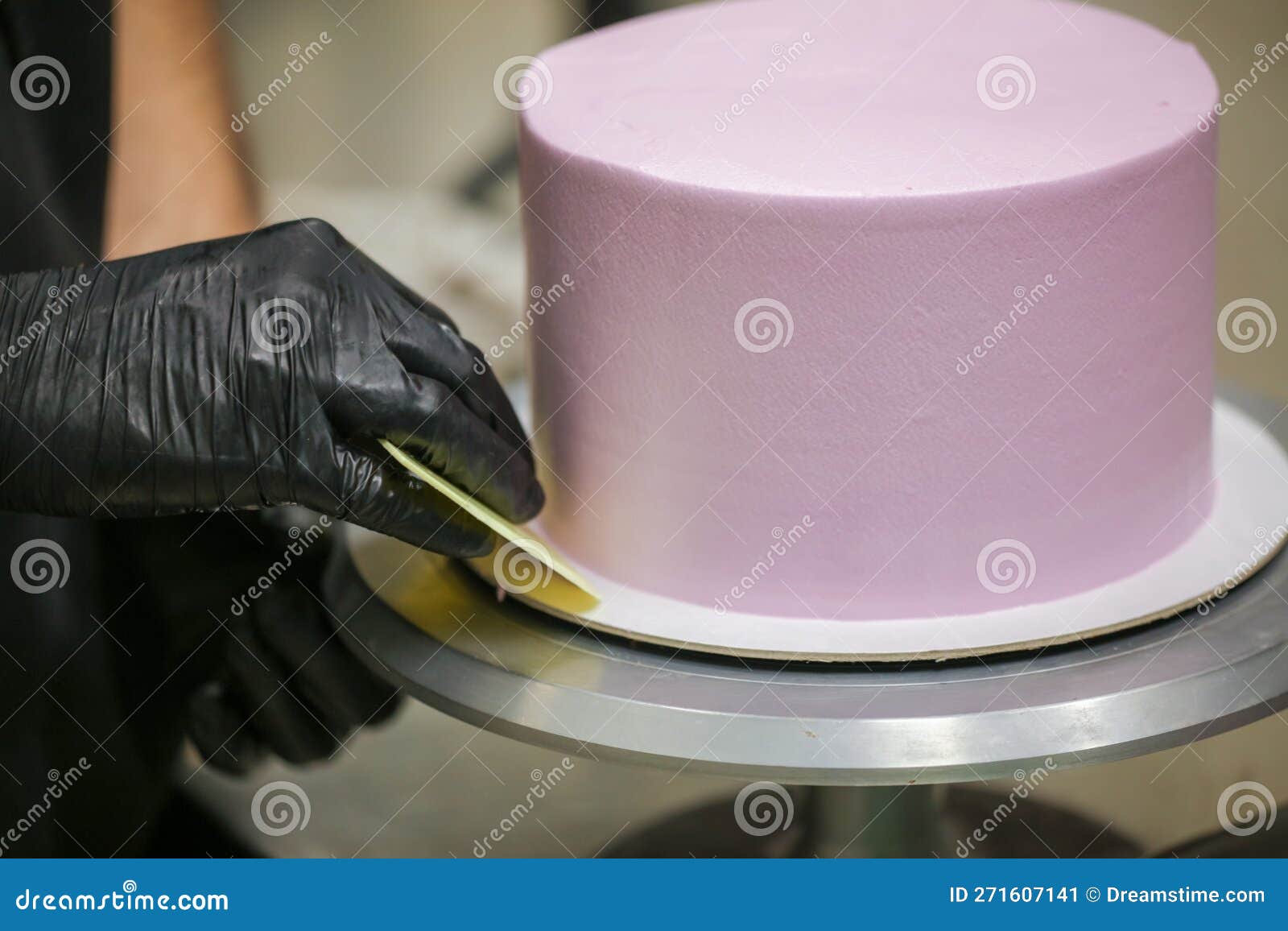 Baker Wearing Protective Gloves Decorating a Beautiful Purple Cake in ...