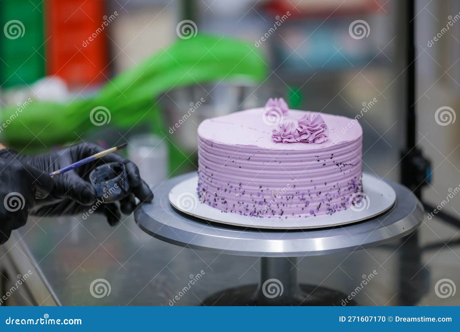 Baker Wearing Protective Gloves Decorating a Beautiful Purple Cake in ...