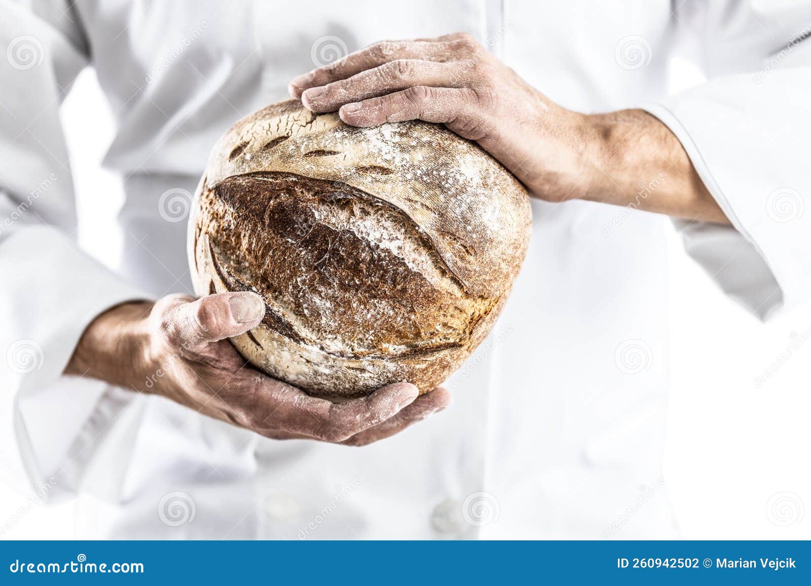 A Baker in White Work Clothes is Holding a Fresh Loaf of Bread Stock ...