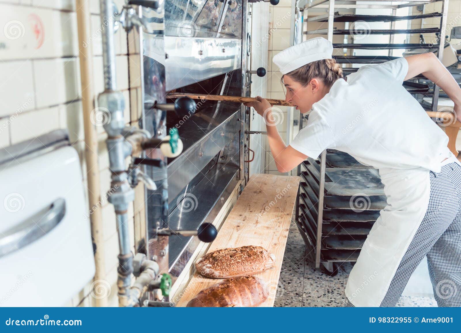 Baker Woman Getting Bread Out of Bakery Oven Stock Image - Image of ...