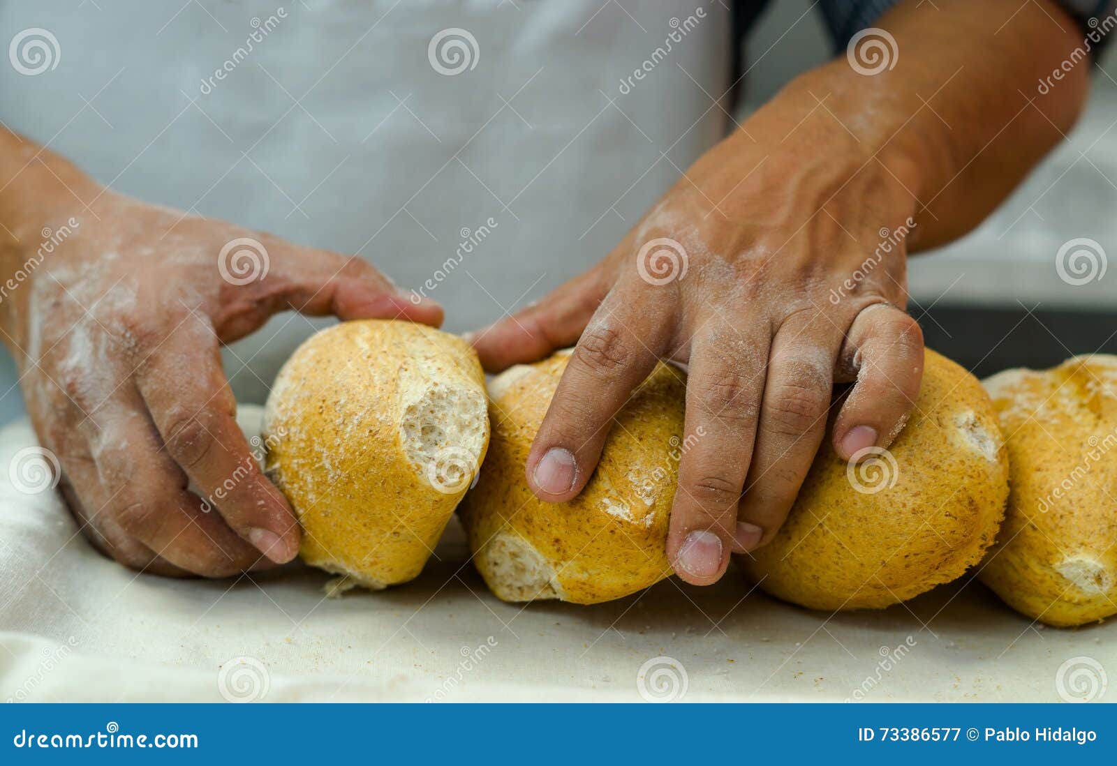 Bakers Hands Placing Half Cut Loaf Of Bread Onto White Plate Next To ...
