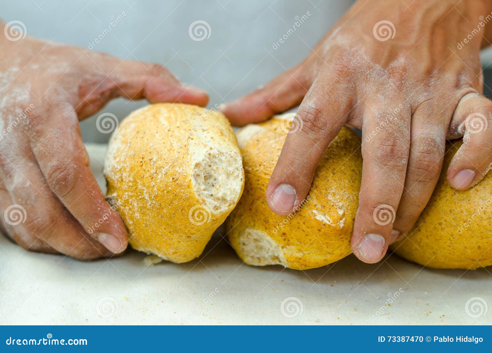 Bakers Hands Placing Half Cut Loaf Of Bread Onto White Plate Next To ...