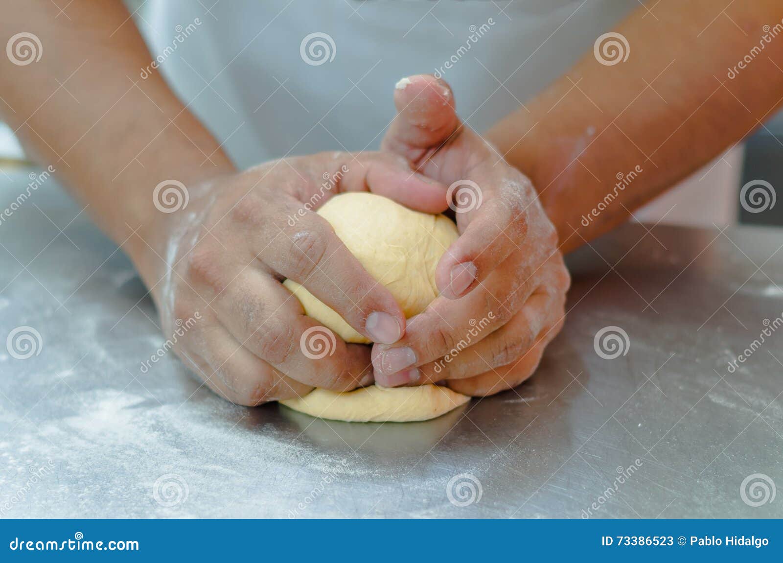 Bakers Hands Placing Half Cut Loaf Of Bread Onto White Plate Next To ...