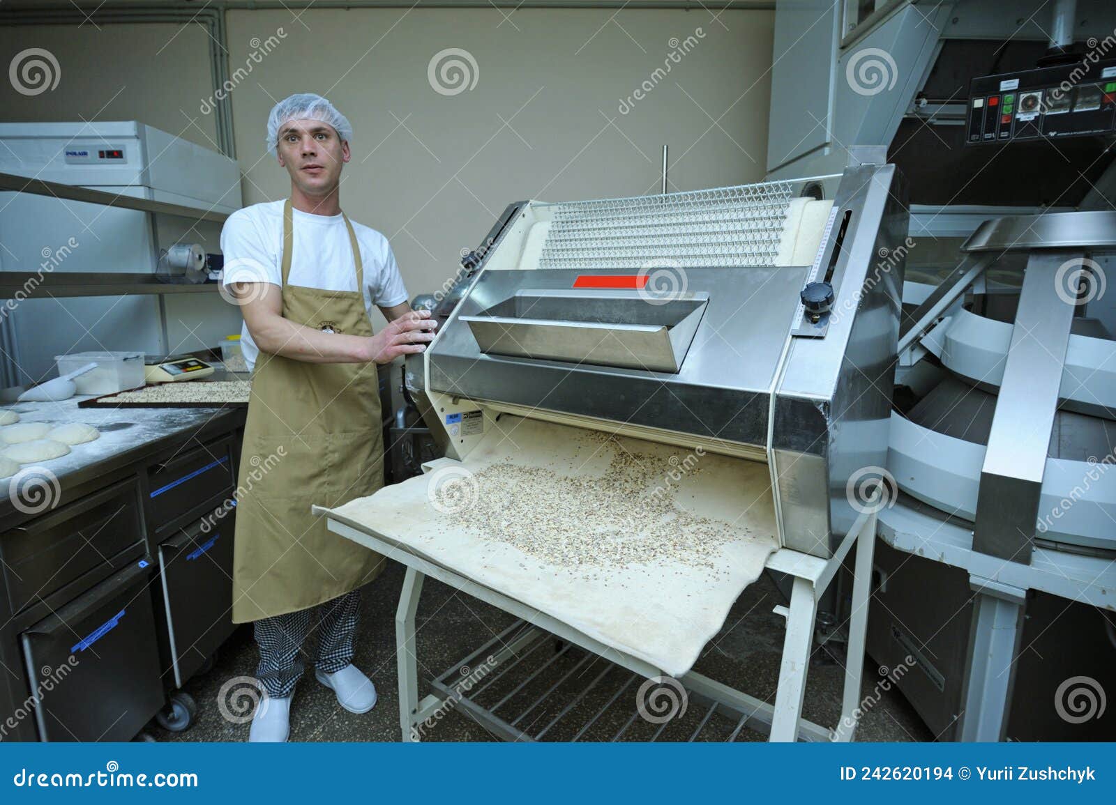 At the Bakery: Baker Working a Dough Forming Machine Forming Dough for ...