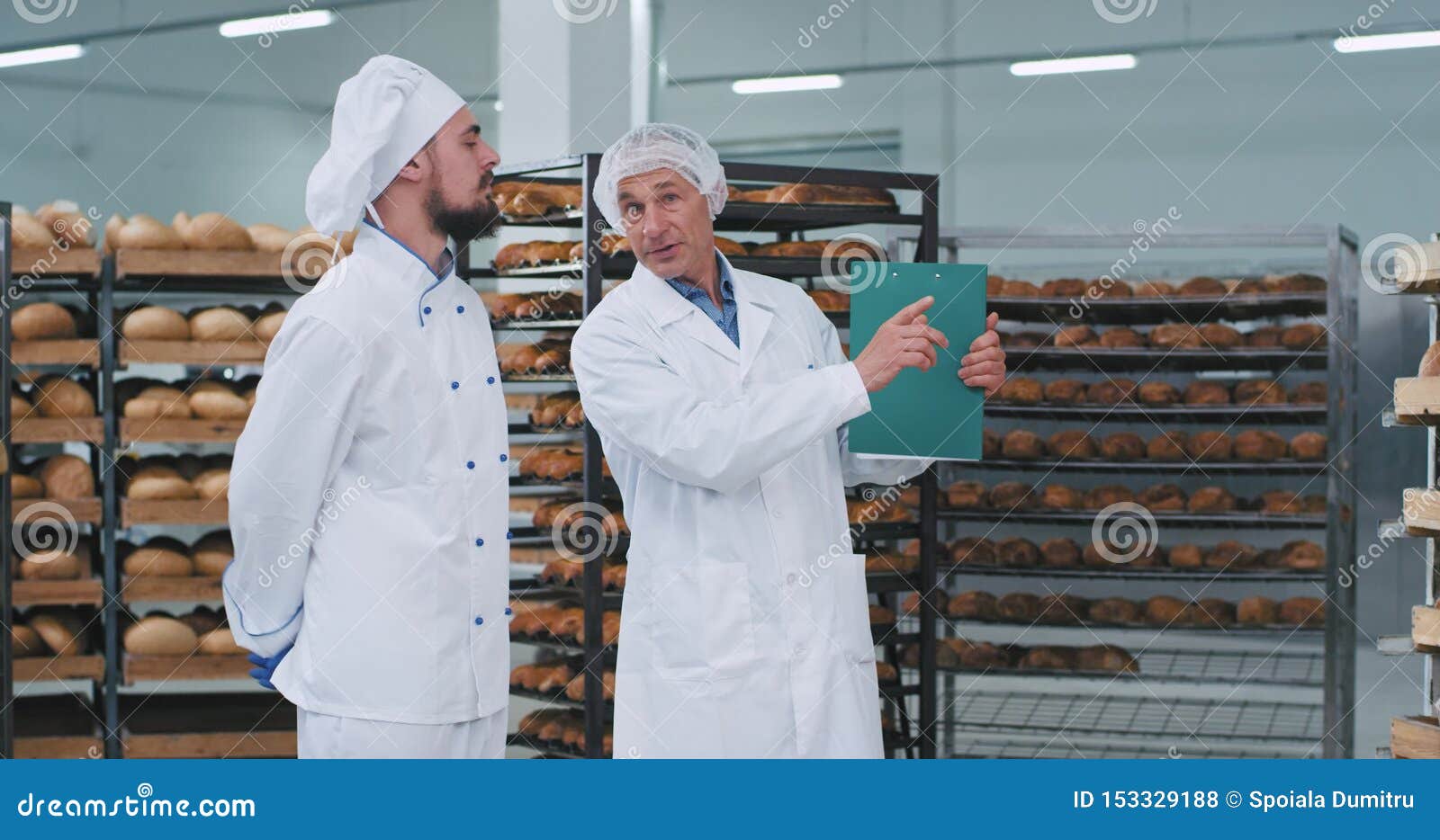 In a Bakery Factory Young Baker and Old Man Engineer Have a ...