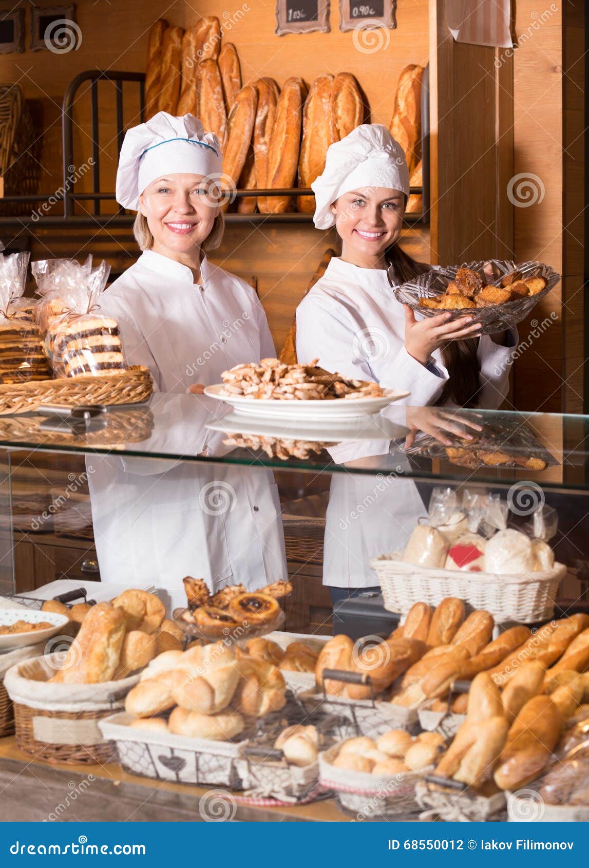 Bakery Staff Offering Bread Stock Photo - Image of aged, pastry: 68550012