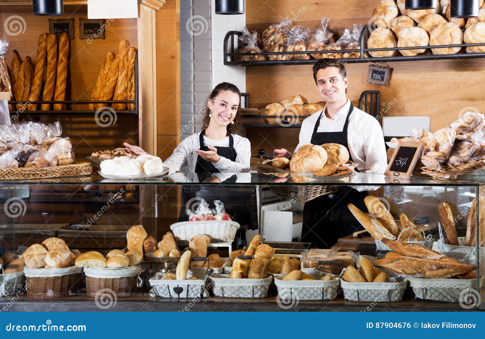 Bakery Staff Offering Bread and Different Pastry Stock Photo - Image of ...