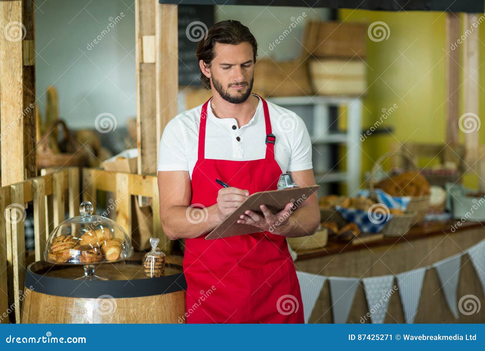 Bakery Staff Writing on Clipboard at Counter Stock Image - Image of ...