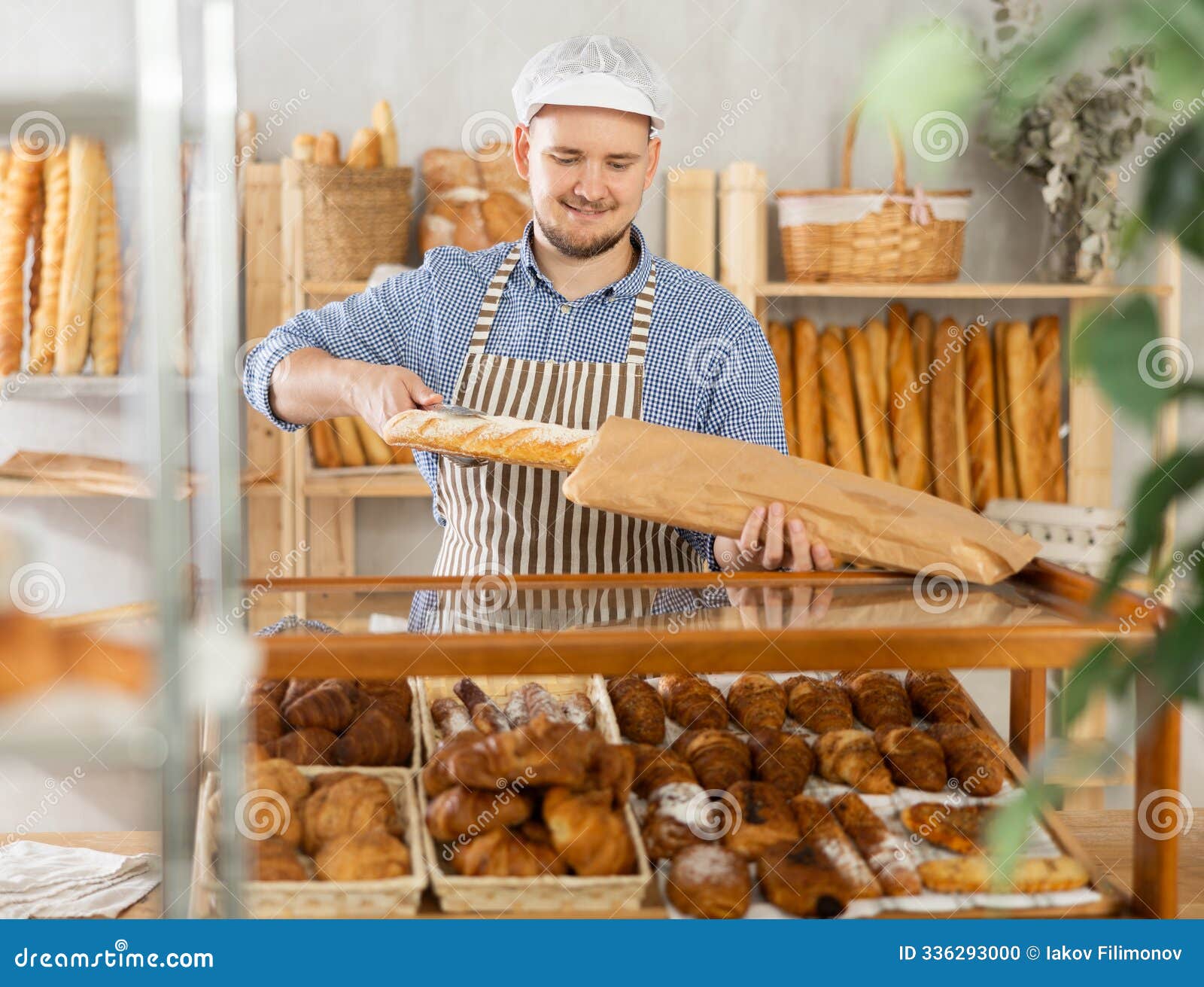 Bakery Worker Places Fresh Baguette in Paper Bag Stock Photo - Image of ...