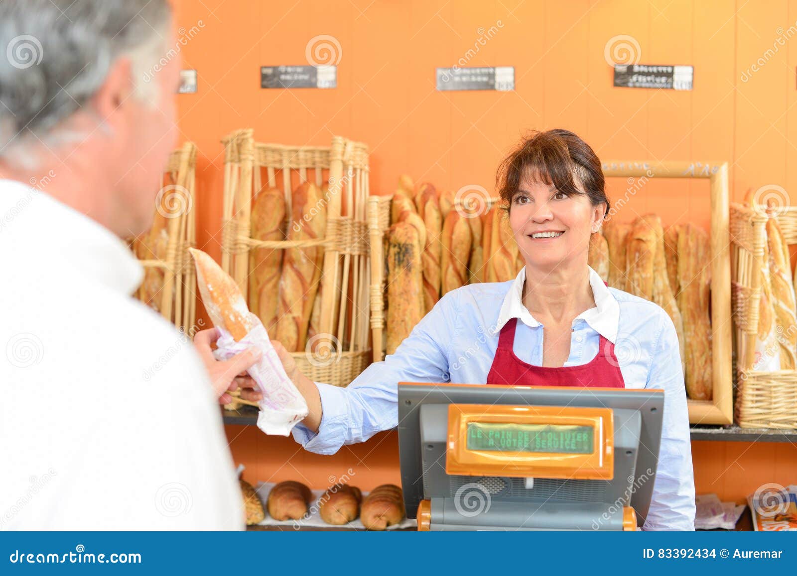 Bakery worker at till stock photo. Image of nutritious - 83392434