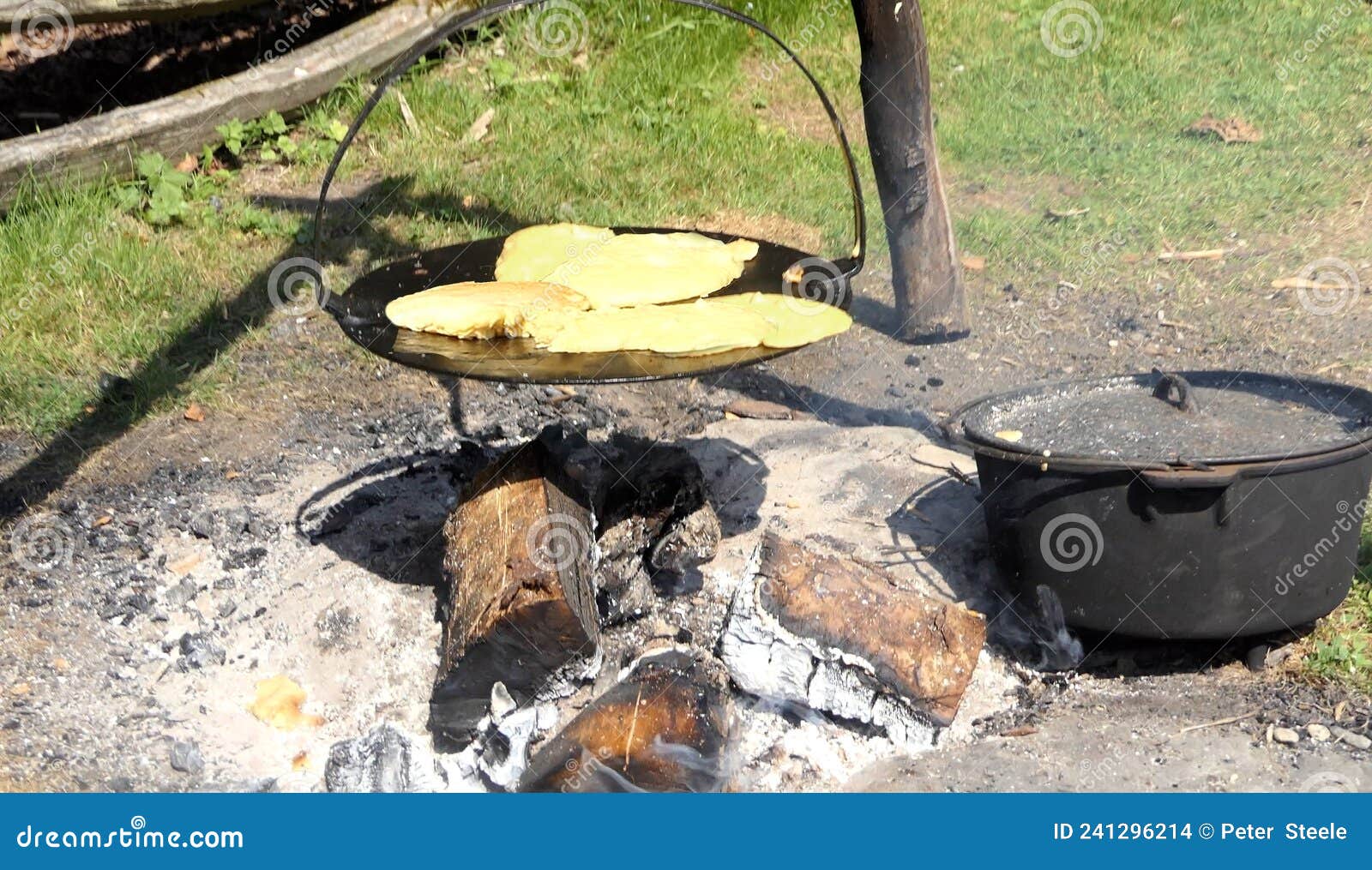 Baking Bread on a Griddle Over Fire Outdoors in 1800`s America Stock ...