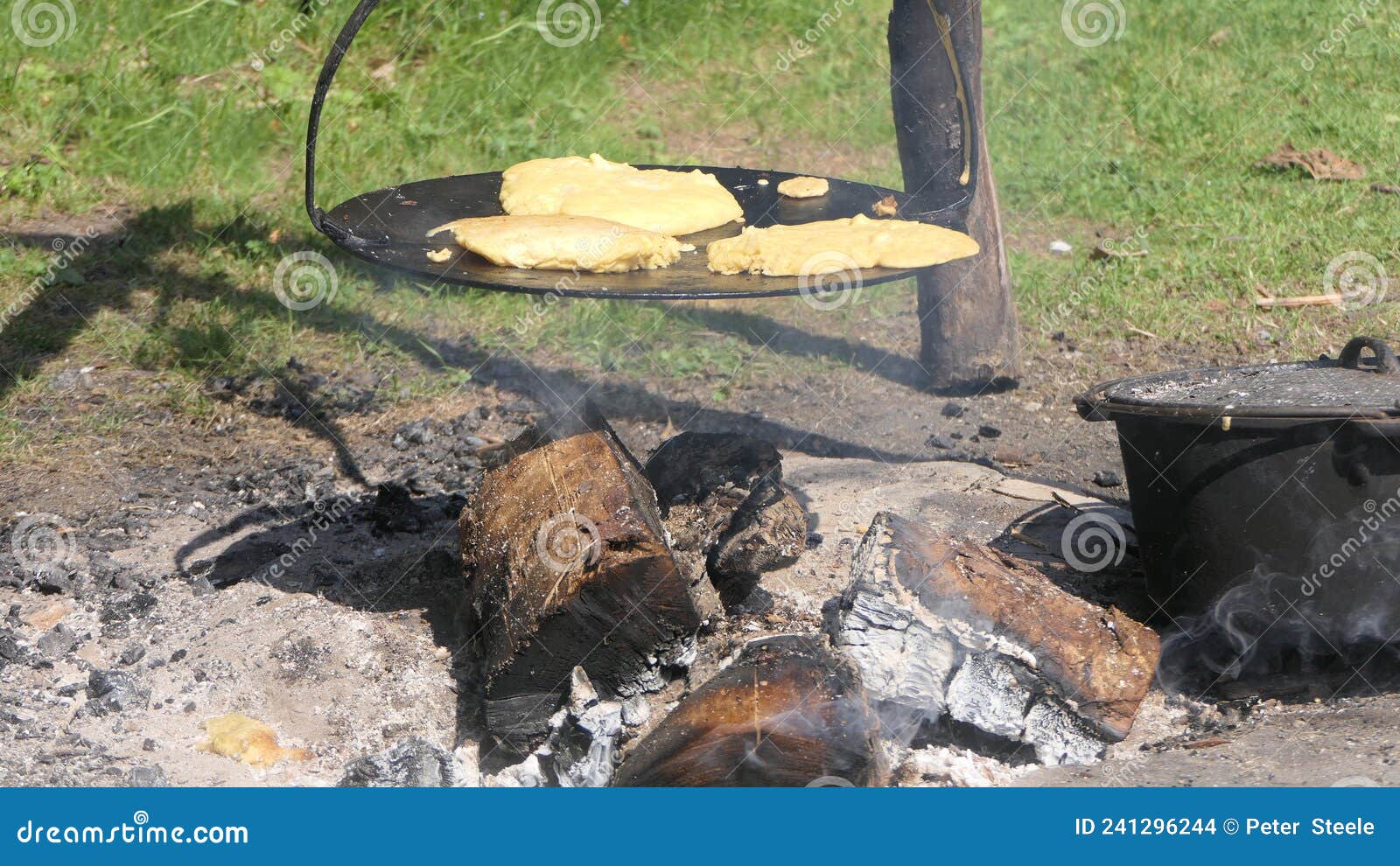 Baking Bread on a Griddle Over Fire Outdoors in 1800`s America Stock ...