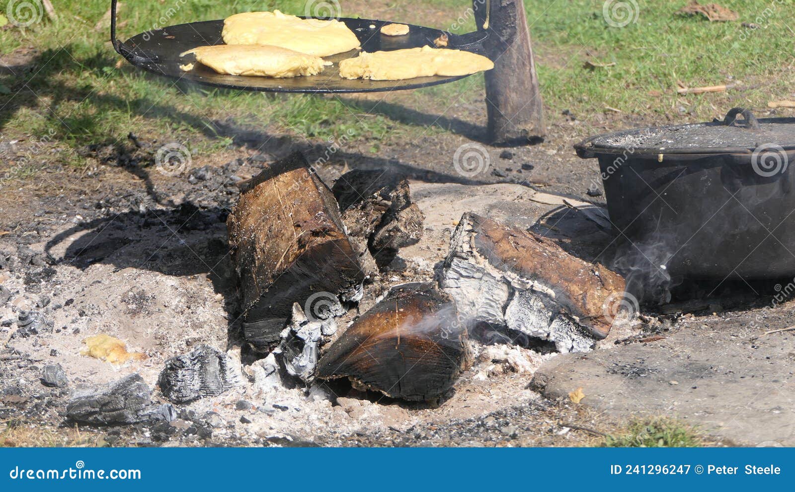 Baking Bread on a Griddle Over Fire Outdoors in 1800`s America Stock ...