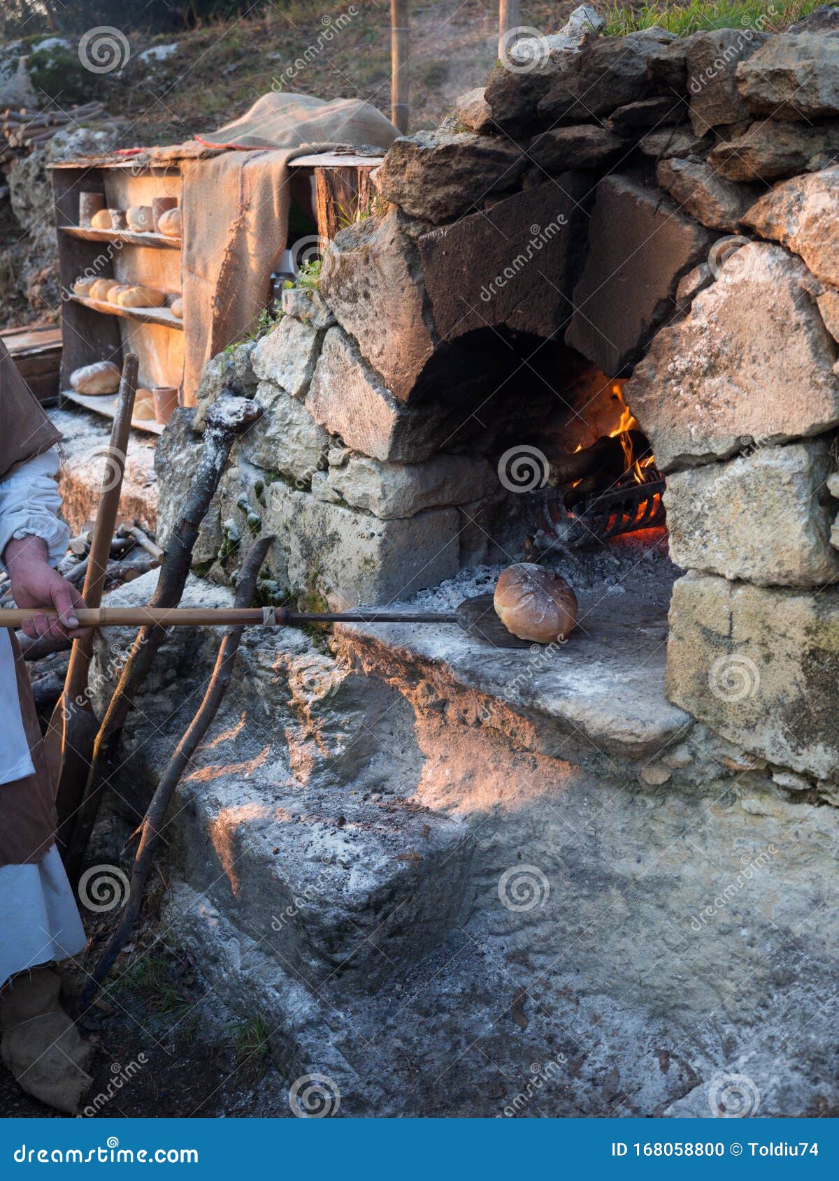 Baking Bread in a Oven Built Using Stones Stock Photo - Image of retro ...