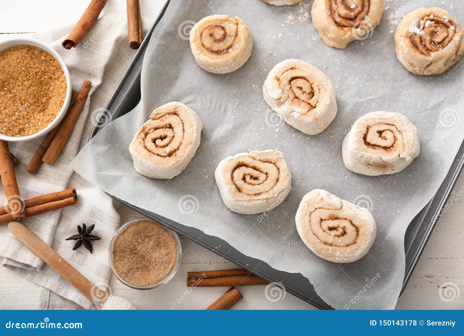 Baking Dish with Uncooked Cinnamon Rolls on Kitchen Table Stock Photo ...