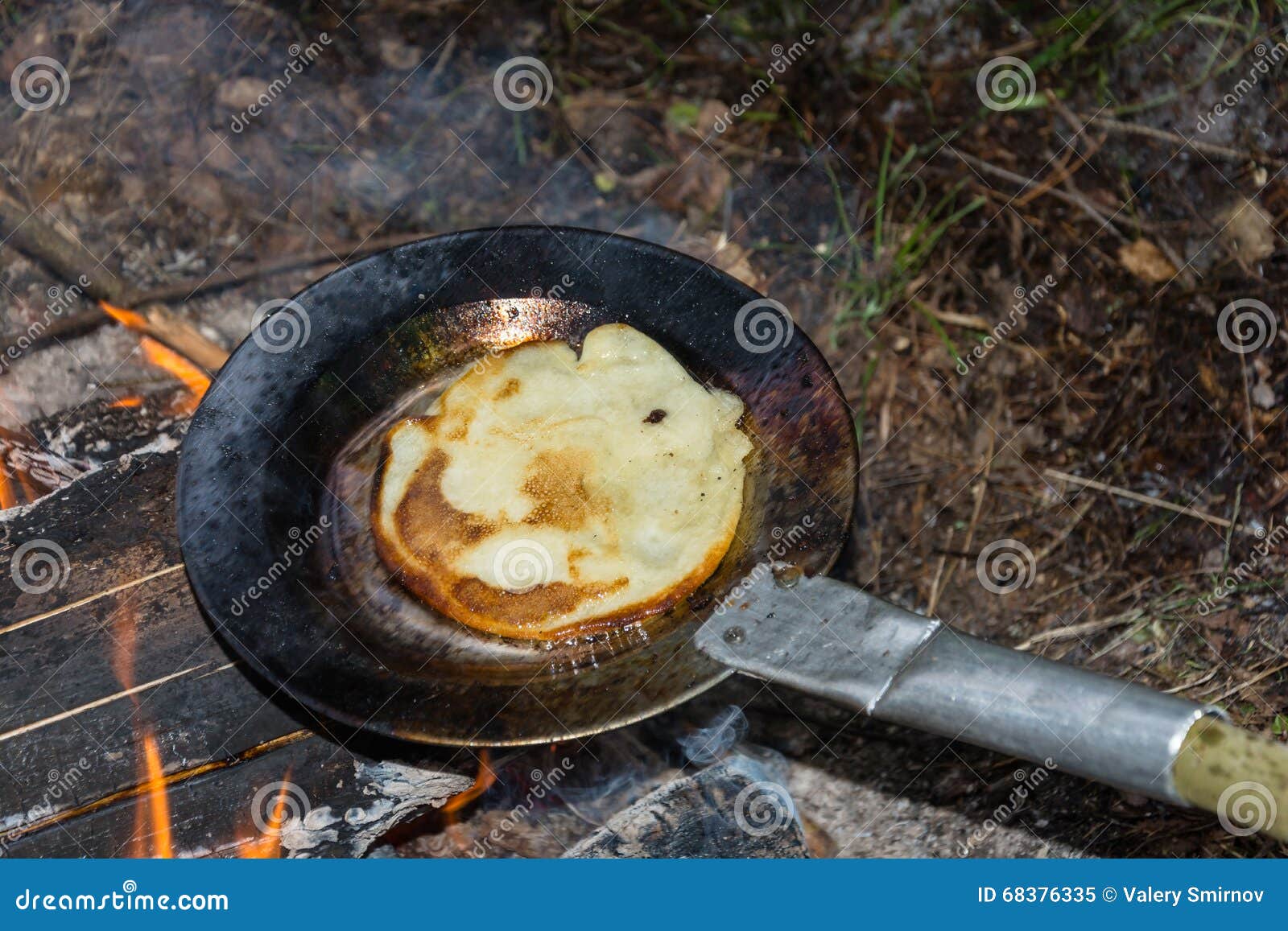 Baking pancakes on a fire. stock image. Image of food - 68376335