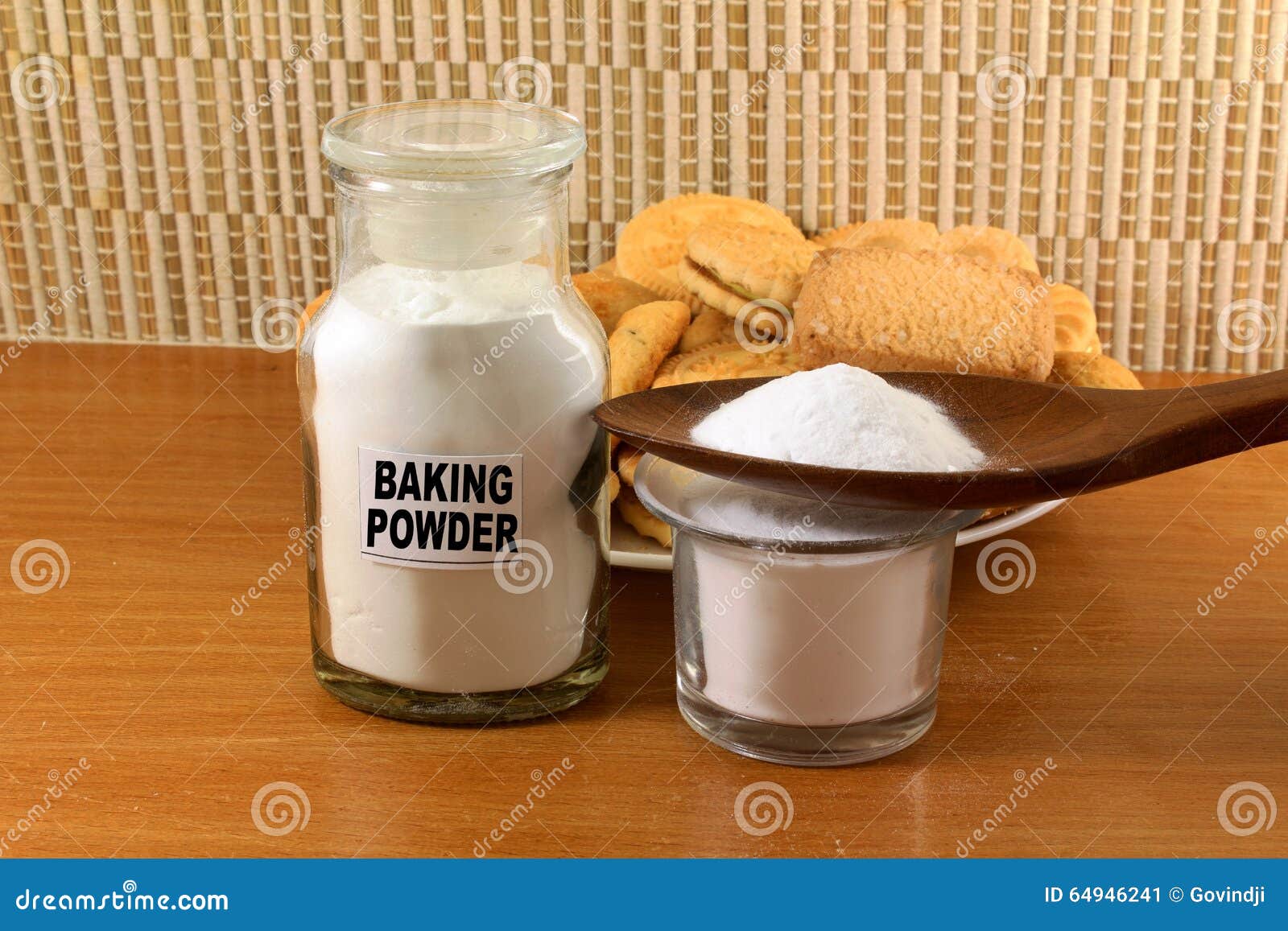 Baking Powder in a Glass Jar and Wooden Spoon with Cookie and Bread ...