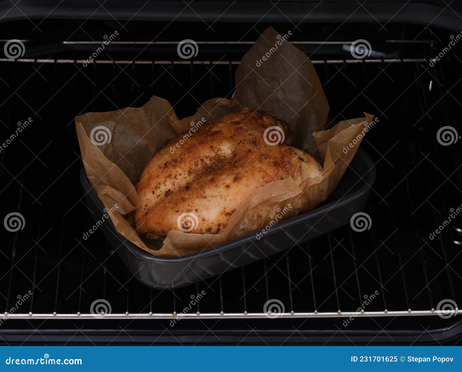A Baking Tray with a Cooked Chicken Breast in it in an Oven Stock Image ...