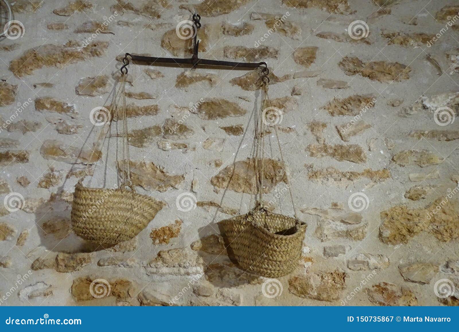 Balance of Two Small Baskets Hanging in a Wall Stock Image - Image of ...