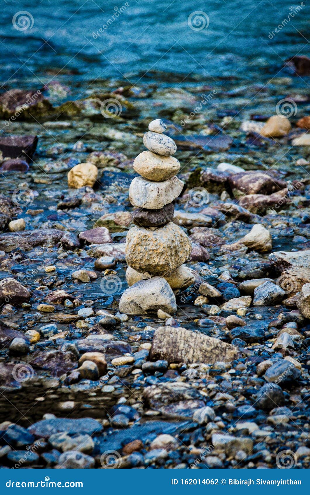 Balanced Stone Tower by the Shore of a River in Banff, Alberta Stock ...
