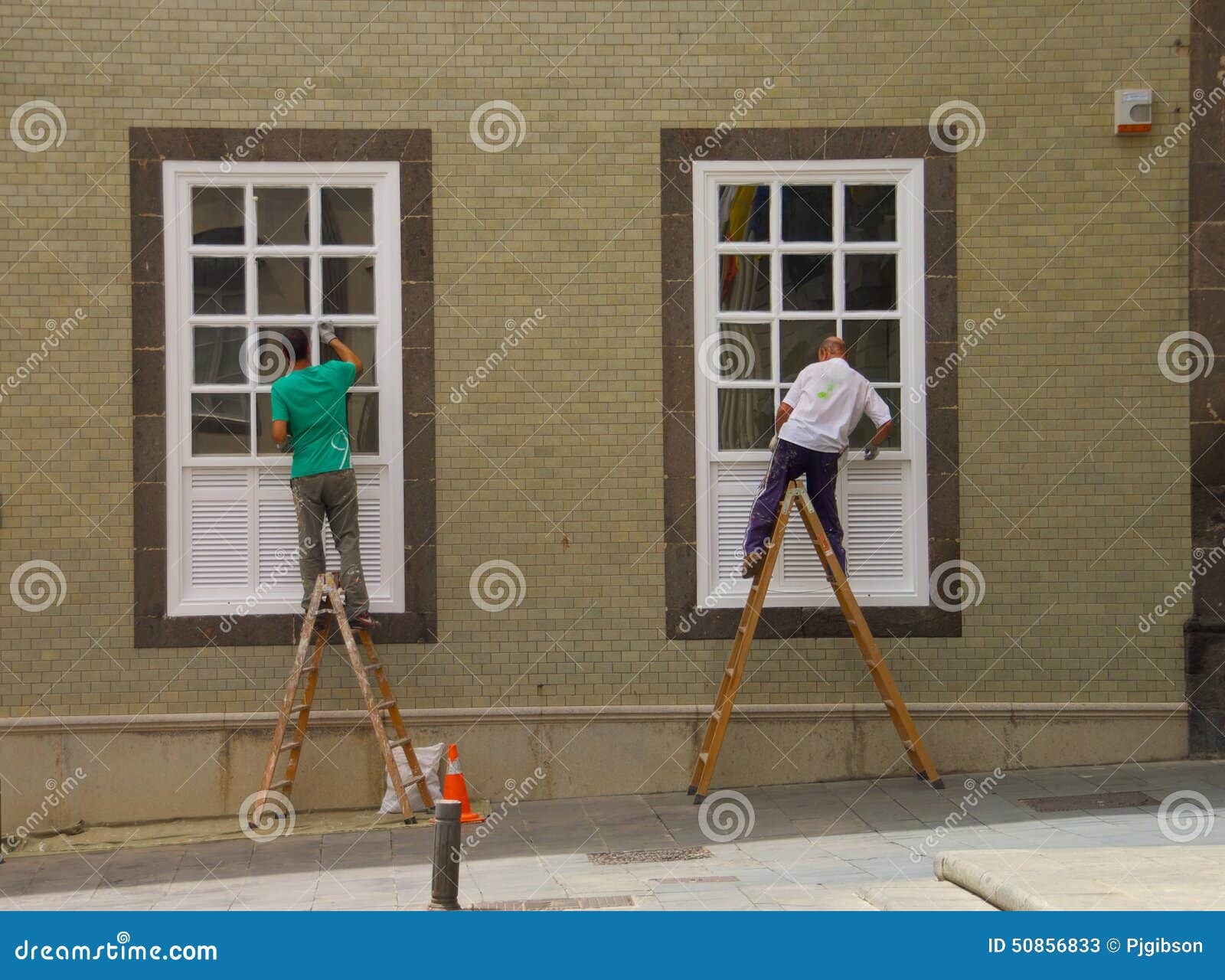 Balanceing Act on ladders stock image. Image of mirror - 50856833