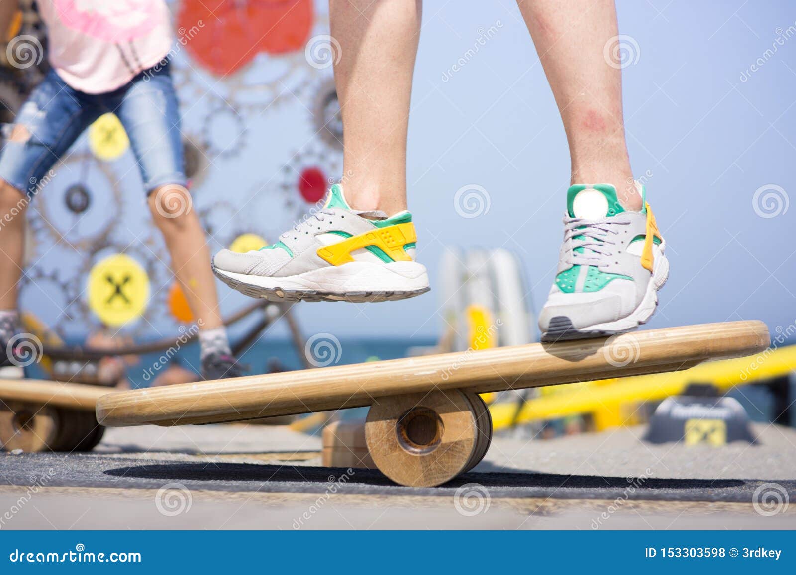 Balancing on a Balance Board in Sunny Weather at the Beach Stock Photo ...