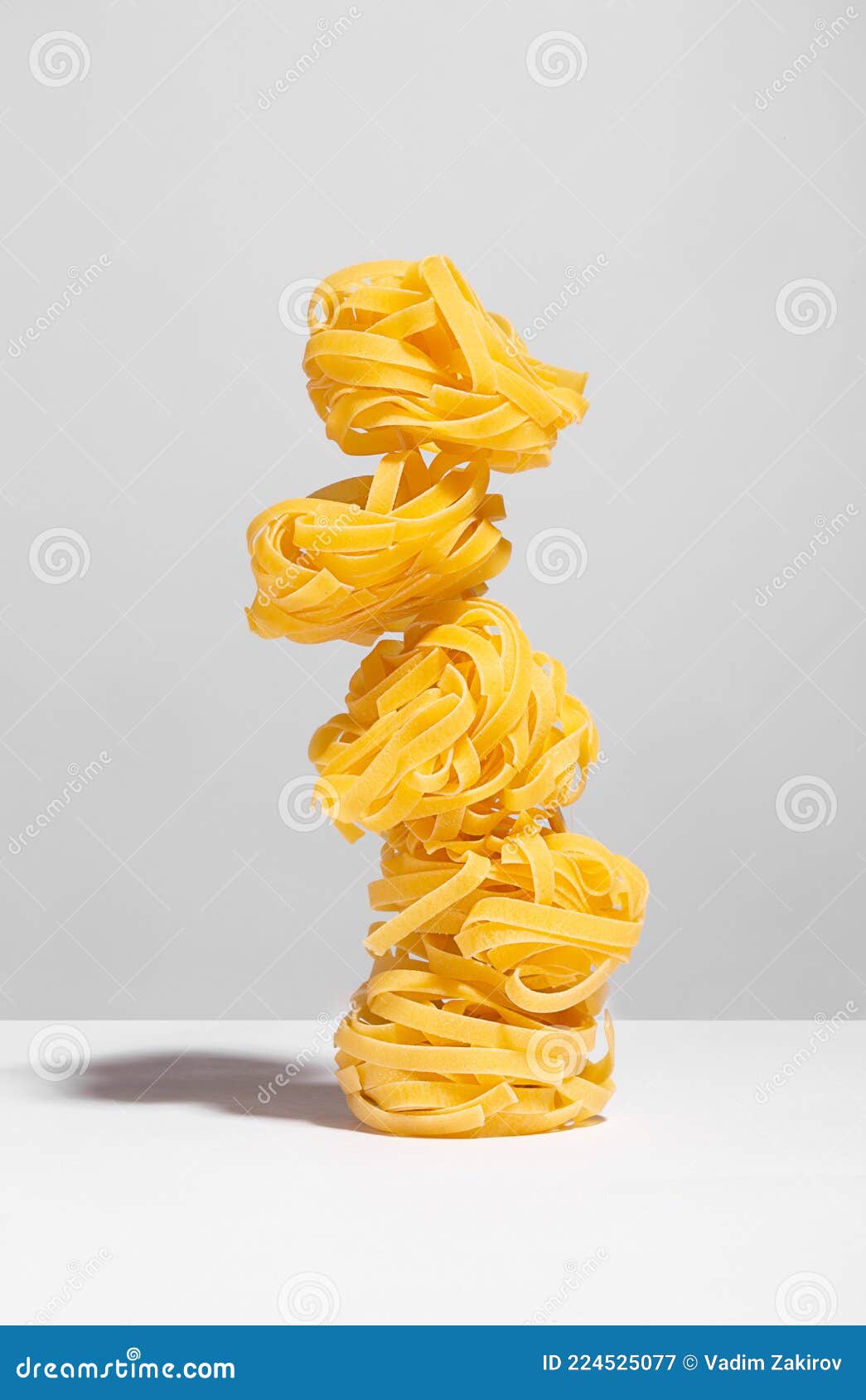 Balancing Pasta in a Stack with a Shadow on a Light Background Stock ...