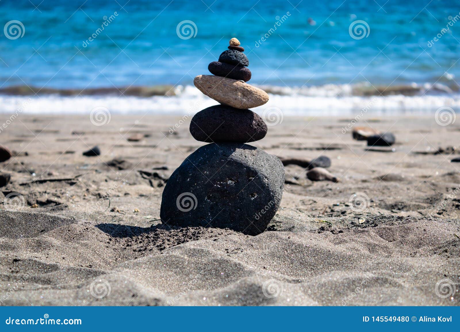 Balancing Stones Composition on the Beach with the Blue Ocean ...