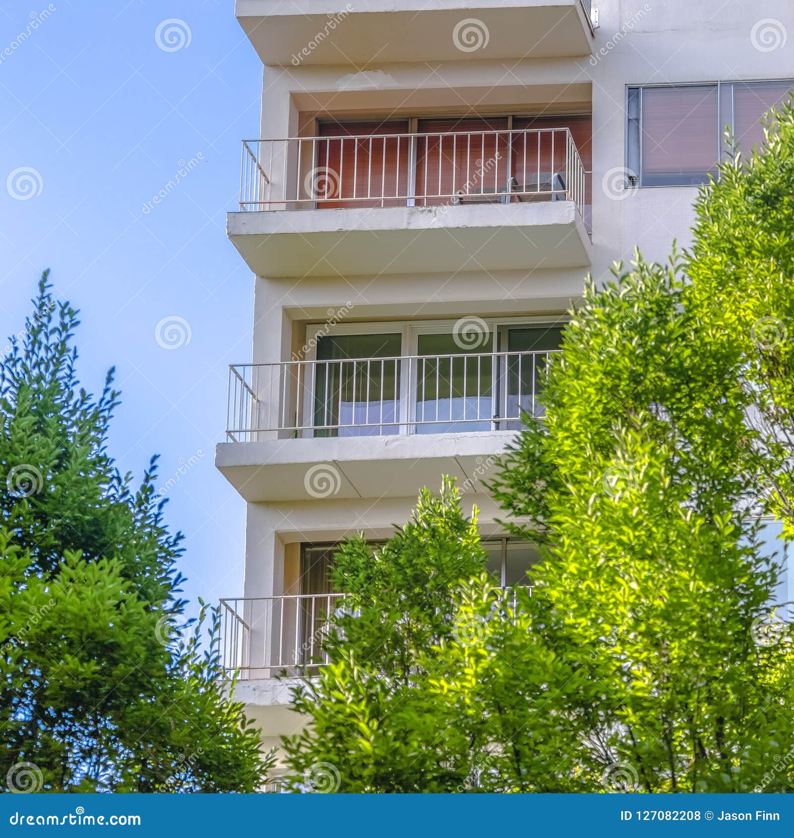 Balconies of a Building with Trees in Front Stock Photo - Image of ...