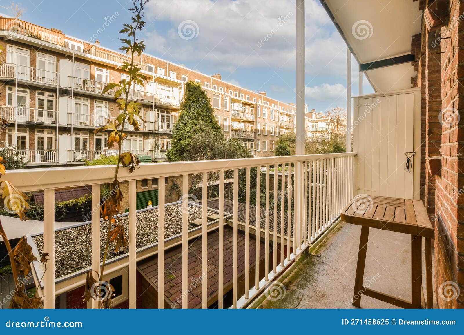 A Balcony with a Table and a Bench on it Stock Image - Image of balcony ...