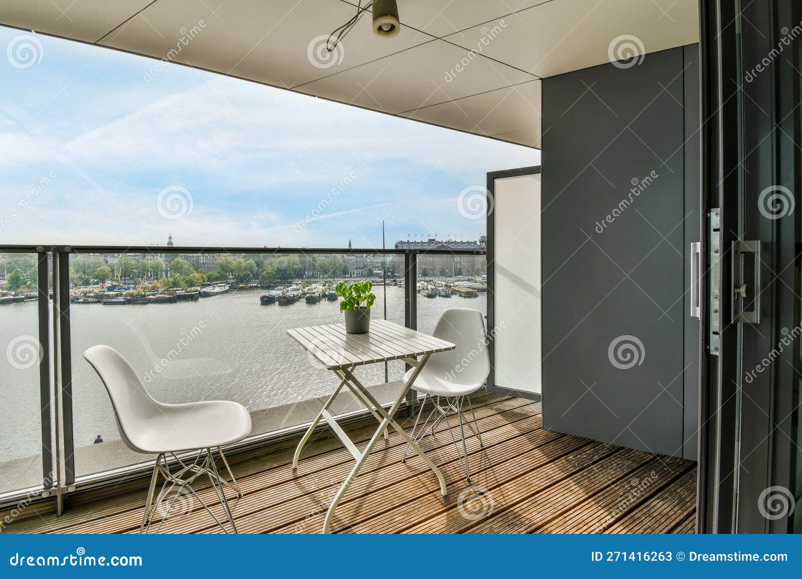 A Balcony with a Table and Chairs Overlooking a River Editorial Stock ...