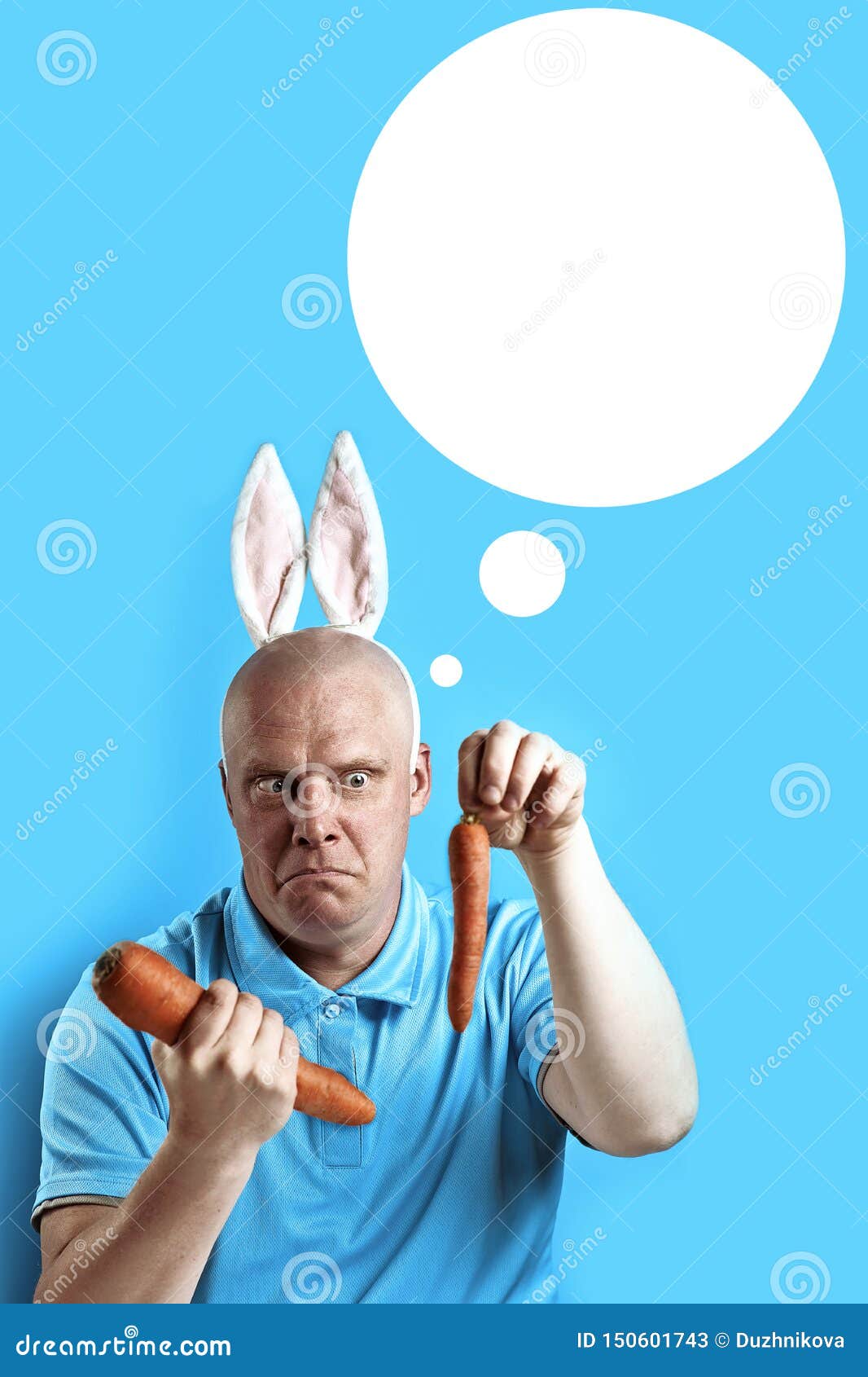 Bald Brutal Man in Light T-shirt and Rabbit Ears. in His Hands he Holds ... Bald Brutal Man in Light T-shirt and Rabbit Ears. in His Hands he Holds ...