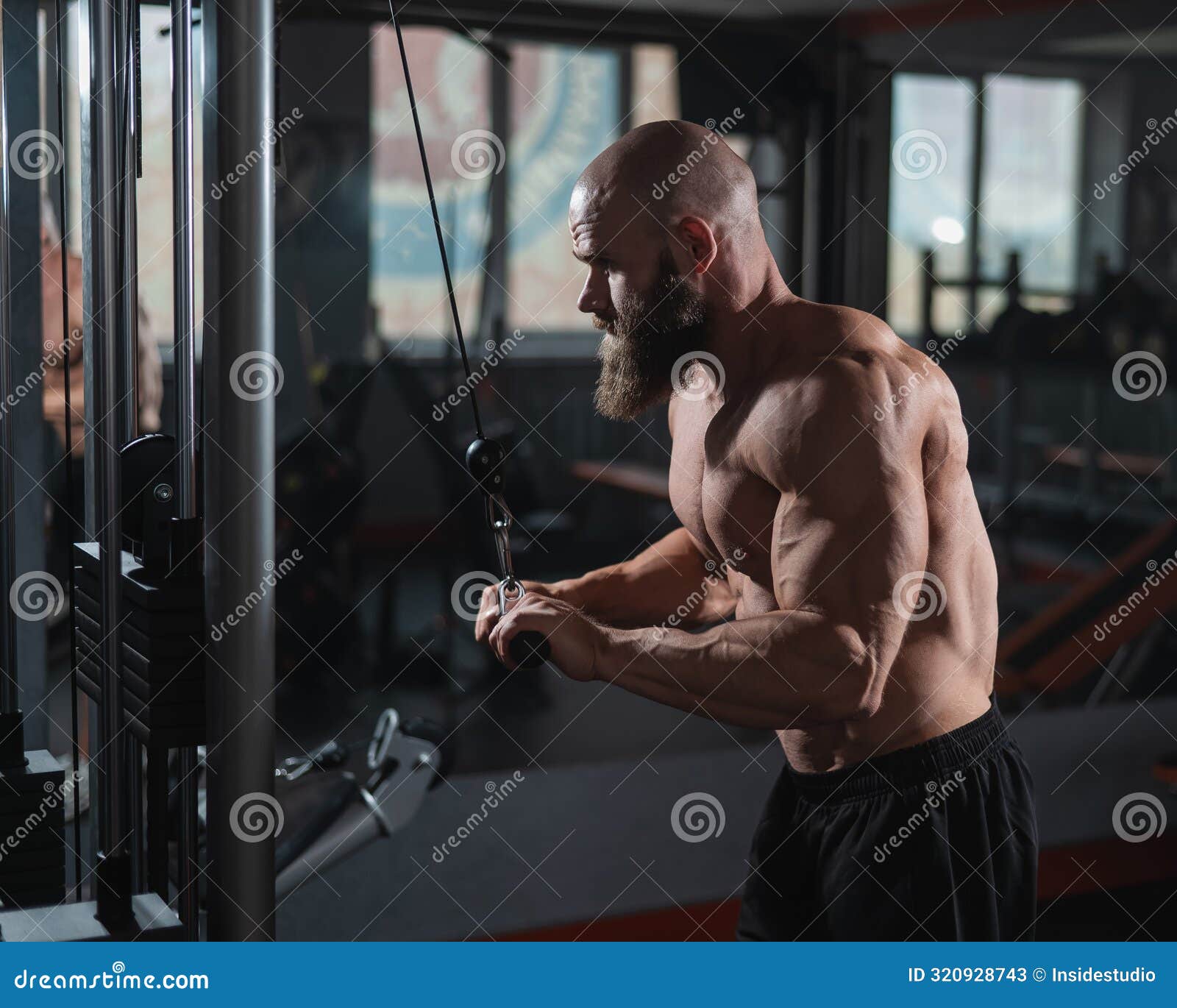 Bald Caucasian Bodybuilder Doing Heavy Triceps Exercises with Cable ...