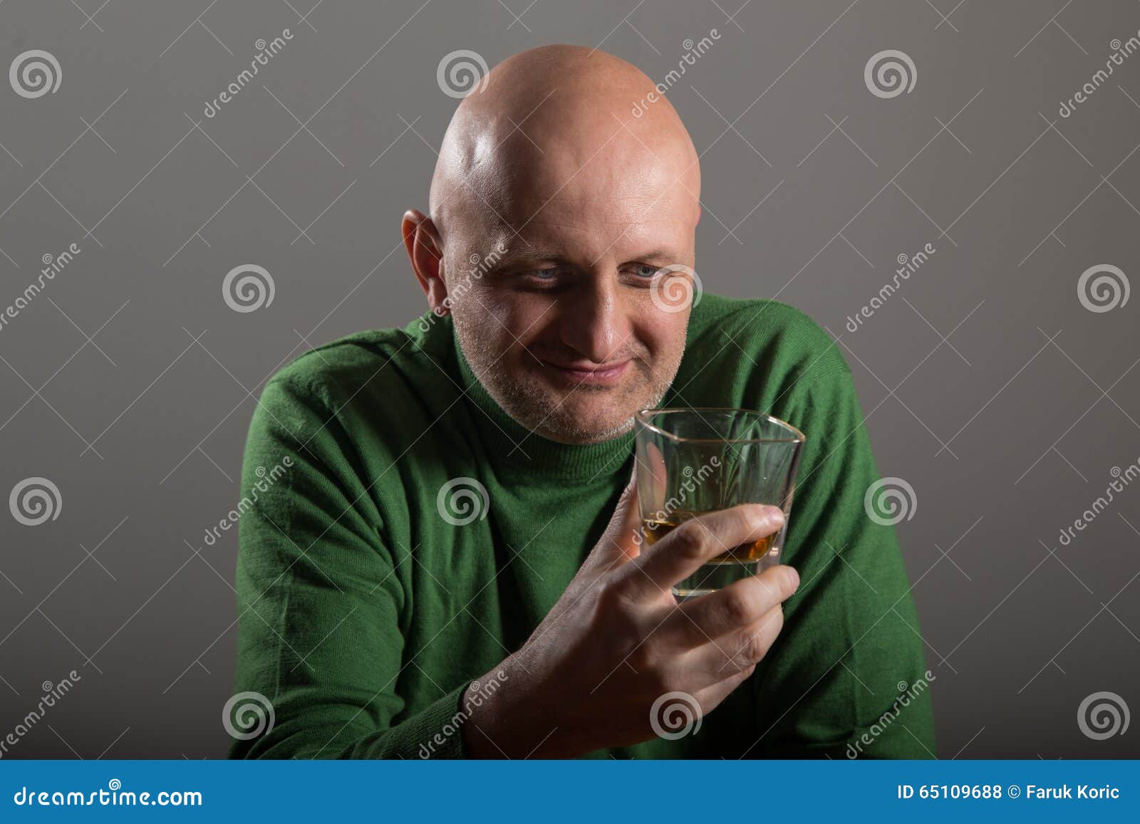 Bald Headed Man Drinking Whiskey Stock Photo - Image of blue, heirless ...